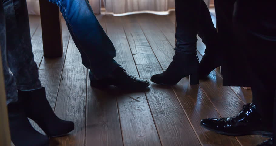 A Man Is Touching A Lady's Leg With His Foot When She Is Sitting Across ...
